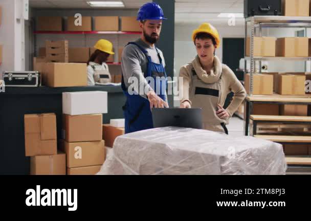 Man and woman thinking about packing goods in boxes, looking at stock ...