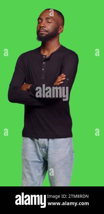 Vertical video: Front view of male model feeling pensive thinking about ...
