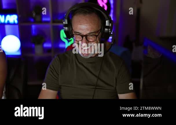 Exciting night in gaming room, two cheerful gamers, father and daughter ...