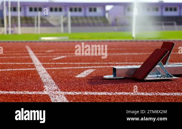 Starting block for a track and field sprinter in a stadium Stock Video ...