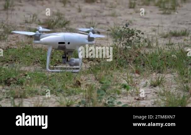 The drone takes off from the ground. The rotors are launched and the ...