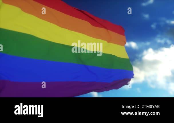 LGBT flag waving in the wind, sky and sun background. LGBT Rainbow Flag ...