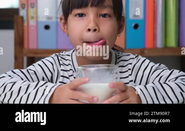 Cute Asian Girl Drinking A Glass Of Milk At Home In Living Room Little 8807
