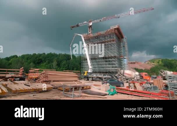 Road bridge support building site with trucks materials and ...