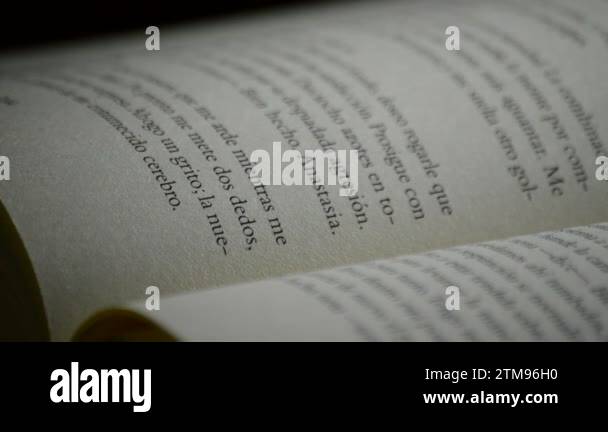 Texts, phrases and words in spanish of a page of a open book rotating ...