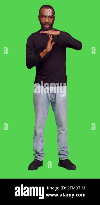 Vertical video: Front view of young model showing timeout symbol in ...