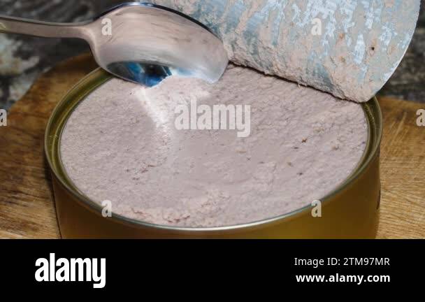 Scoop up the pate with a spoon. Slow motion. Liver pate is eaten from a ...