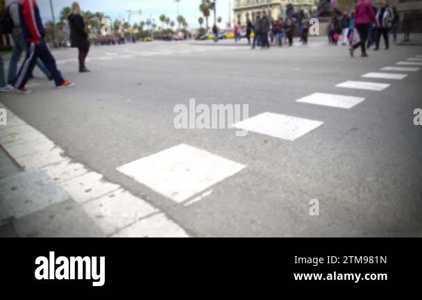 Crowd of locals and tourists crossing street, rush hour traffic, big ...