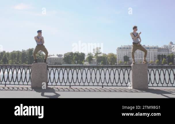 Two men in marine uniform show weird movements, staying on postament at ...
