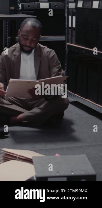 Vertical video: Team of police officers working with forensic evidence ...