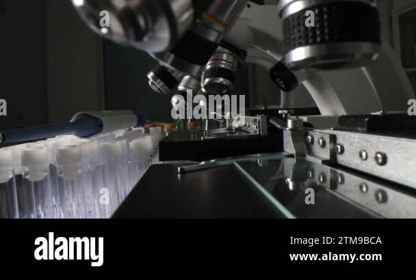 Microscopes with glass slides and test tubes in chemical laboratory ...