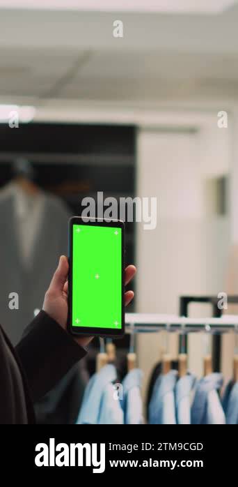 Vertical video: Young assistant using blank greenscreen template ...
