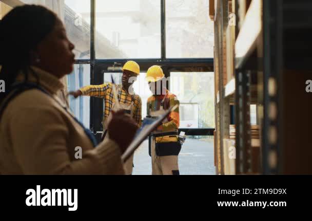 Team of men working on stock inventory in warehouse, scanning ...