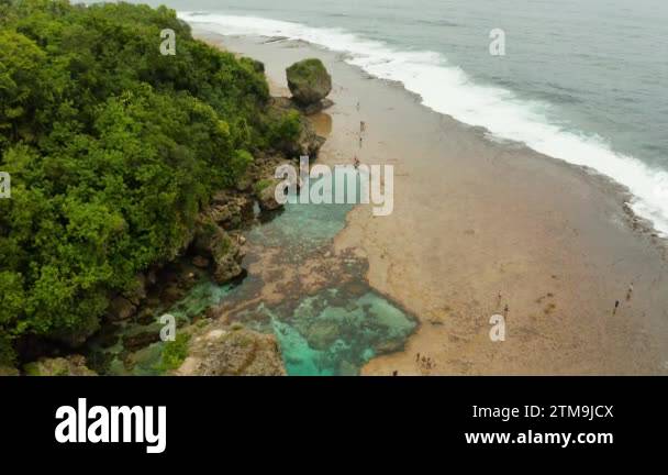 Tropical beach with natural rock pools. Magpupungko natural rock pools ...
