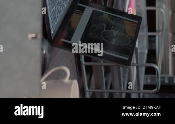 Vertical video: African american man examining photos on laptop ...