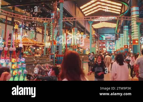 Happy family and kids is having fun together in indoor amusement park ...