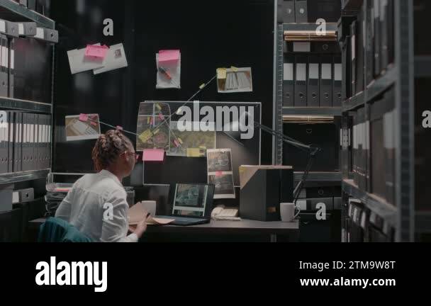 Private detectives checking crime scene photos on map, working to find ...