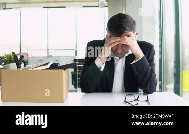 Senior employee sitting with dismissal box. Man by dismissal. Senior ...