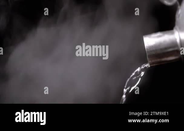 Jet of Boiling Water from a Kettle Pours on the Background of Clubs ...