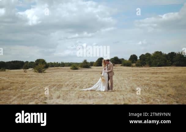 Tender loving bride and groom standing together facing each other and ...