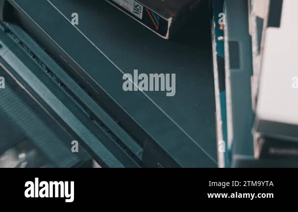 Insert VHS cassette into VCR player. Black vintage videotape cassette ...