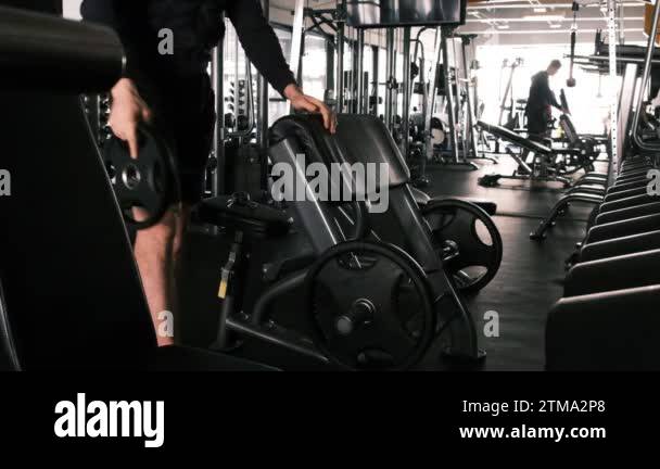 Barbell bench press. A young athlete on a simulator in a supine ...