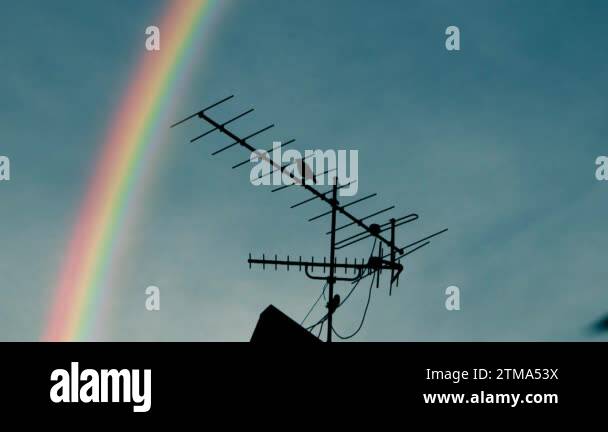 Rainbow, Tv antenna and a crow, roof top, house, bird Stock Video ...