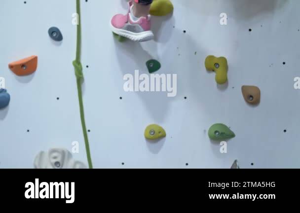 Sports climbing. Female athletes legs confidently rest on the supports ...