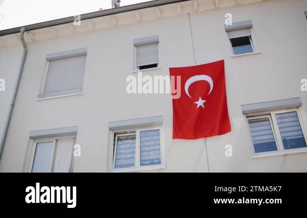 A Turkish flag hanging on the facade of a residential house in the ...