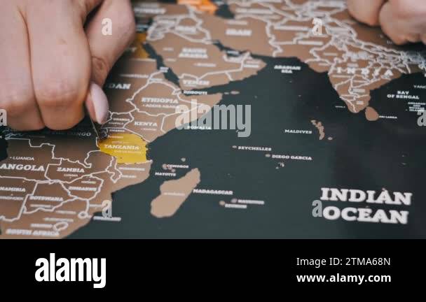Woman hand erases visited country of Tanzania on the travel map ...