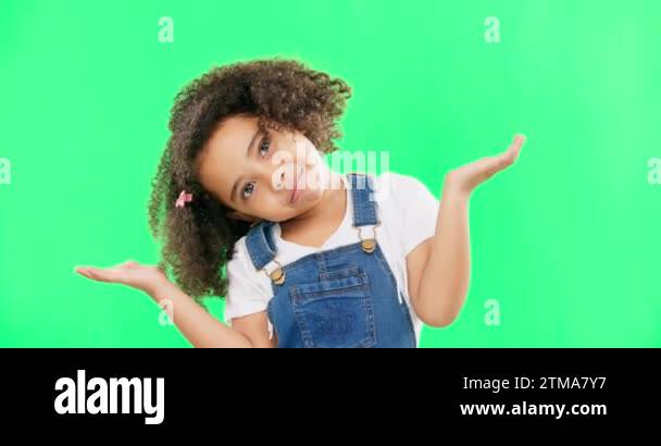 Kids, doubt and a confused girl shrugging her shoulders on a green ...