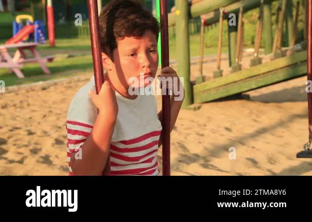 Boring cute little boy at the playground Stock Video Footage - Alamy