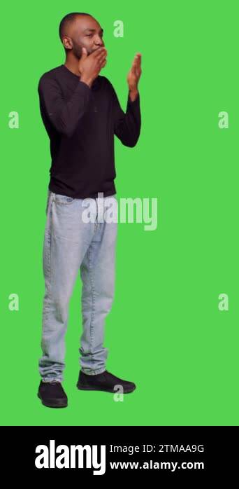 Vertical video: Side view of african american man sending air kisses on ...
