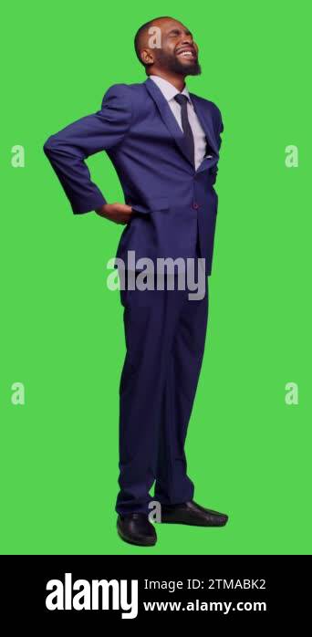 Vertical video: Side view of male office worker suffering from spine ...