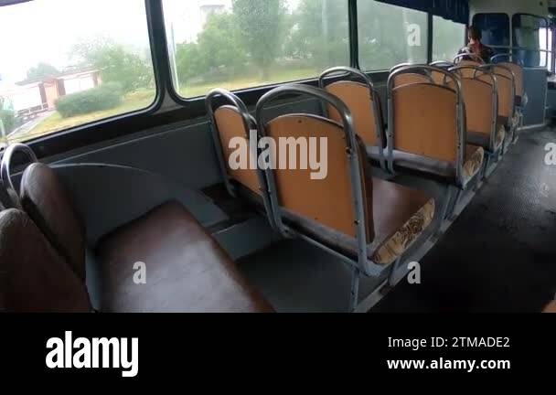 Man riding bus. Woman sitting on seat and riding inside empty old ...