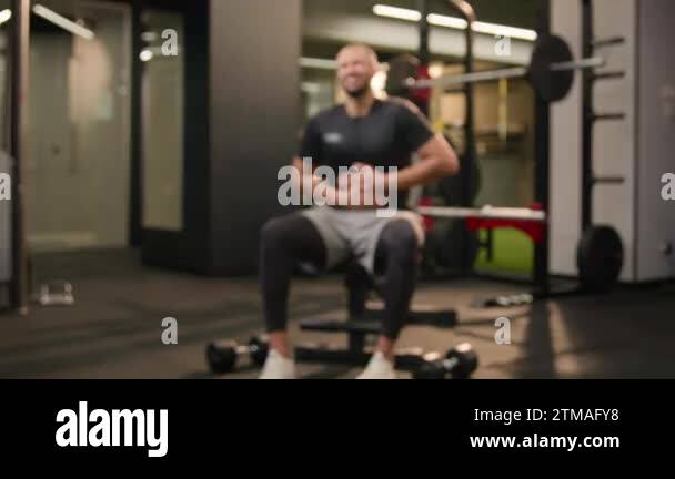 African American multiracial sportsman athlete bodybuilder in sport gym ...