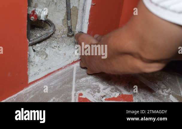 Craftsman makes an inspection opening in plasterboard wall Stock Video ...