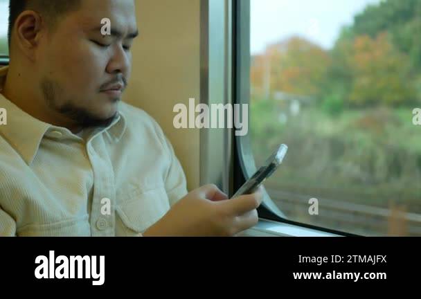 A man in a commuter train subway metro traveling and uses the ...