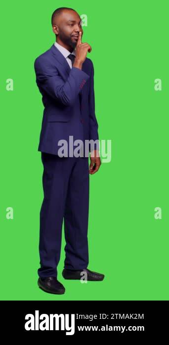 Vertical video: Side view of african american worker doing hush silence ...