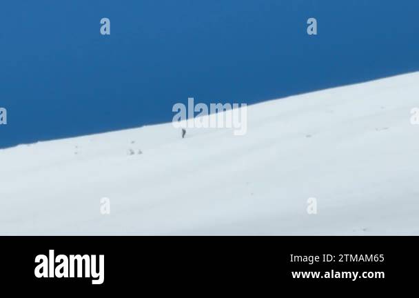 Cinematic Aerial downhill freeride skiing in fresh deep snow with ...