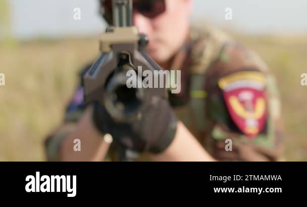 serious guy shoots with a revolver at targets on the shooting range ...