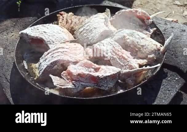 Fish is fried in frying pan close up. Cooking fresh fish catch ...
