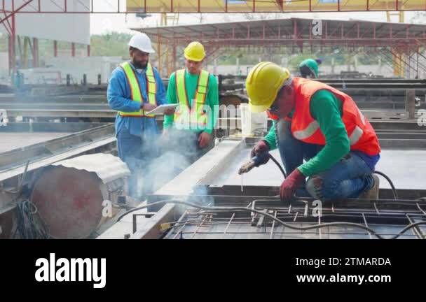 Young asian worker using machine welding iron with hands working while ...