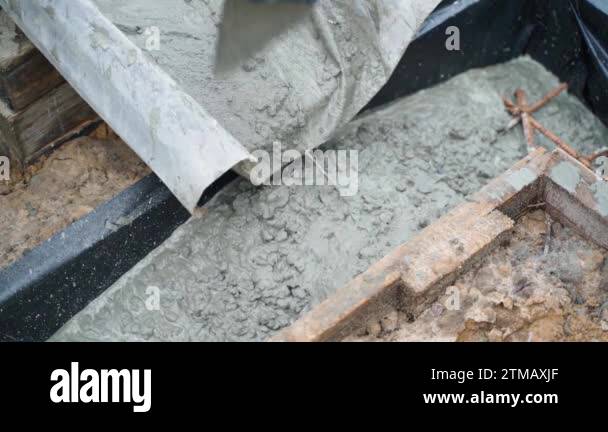 A hand with a trowel rakes the remains of the mortar into the ...