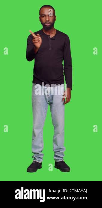 Vertical video: Front view of confident man expressing denial and ...