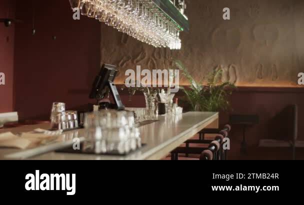 Handheld interior design shot of counter with glassware and computer ...