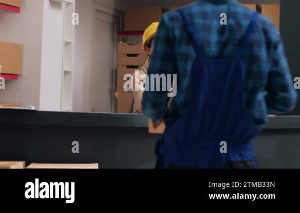 Female employee scanning barcodes on goods for stock logistics, using ...