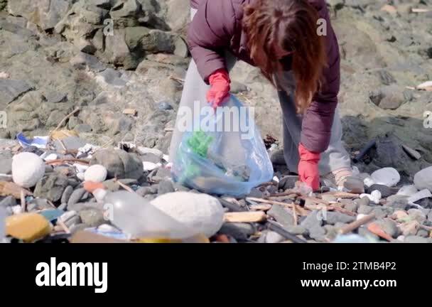 recycling and waste management. womancollecting plastic bottles to ...