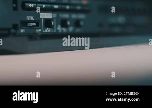 Insert VHS cassette into VCR player. Black vintage videotape cassette ...