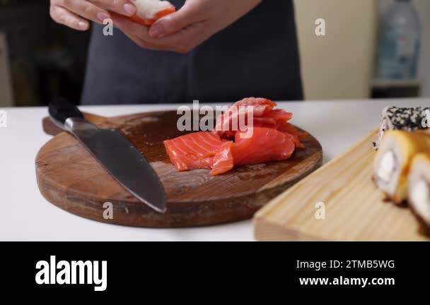 chef's hands preparing Japanese food. Japanese chef prepares sushi in a ...